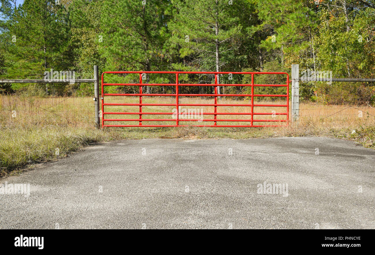 horizontal image of a red entry gate to a field in the country Stock ...
