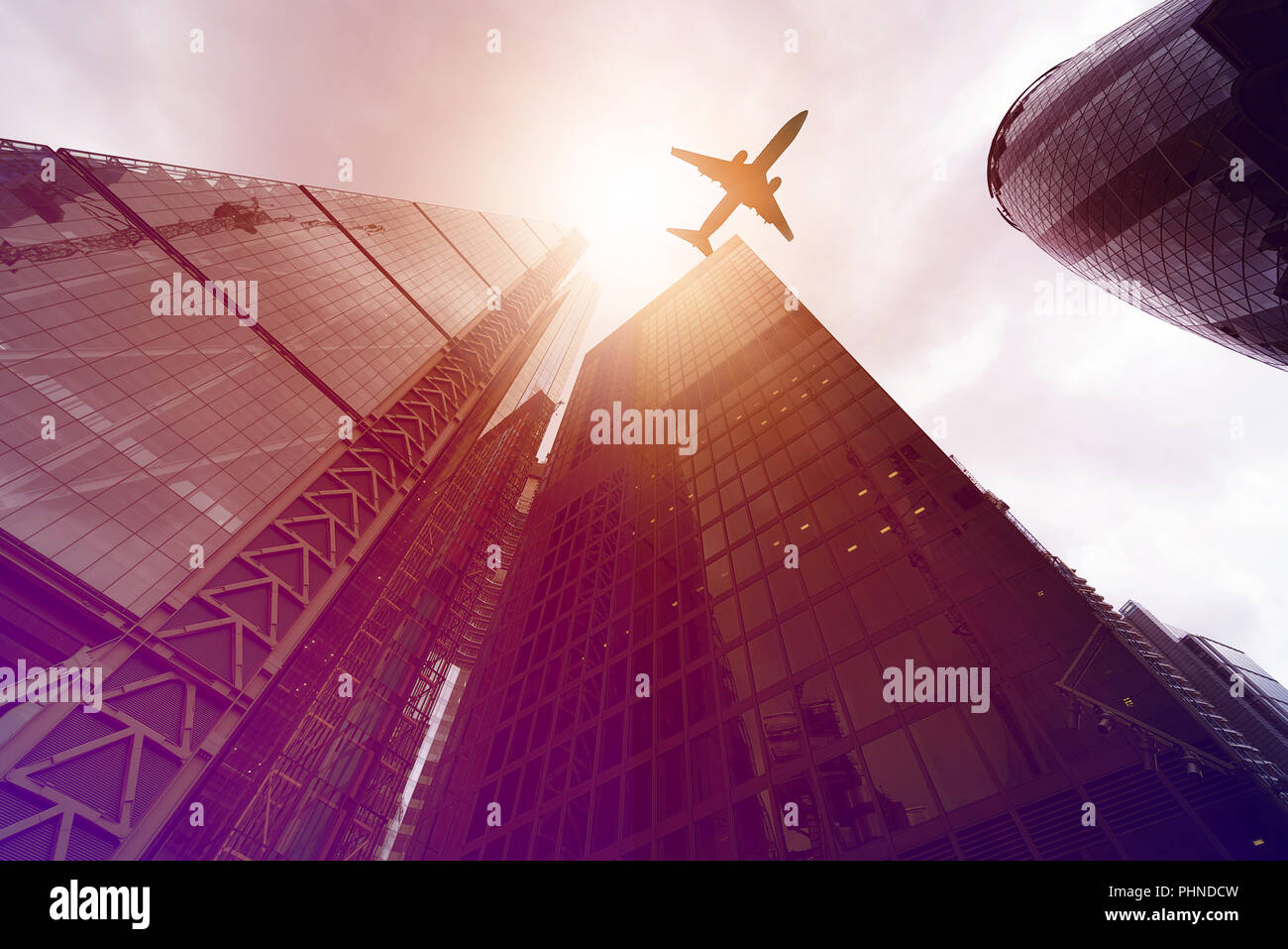 plane over highrise buildings Stock Photo - Alamy
