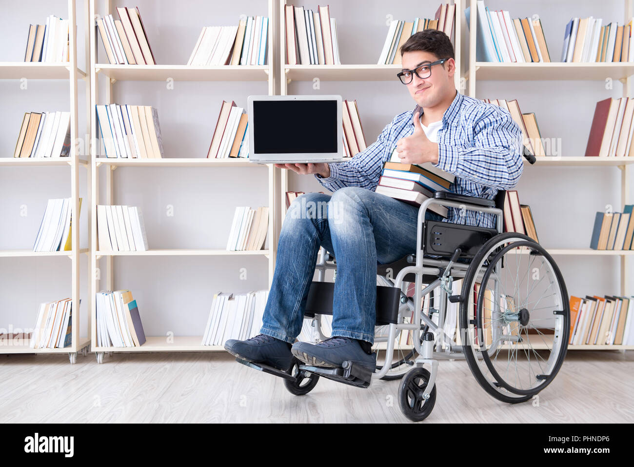 Disabled student studying in the library Stock Photo - Alamy