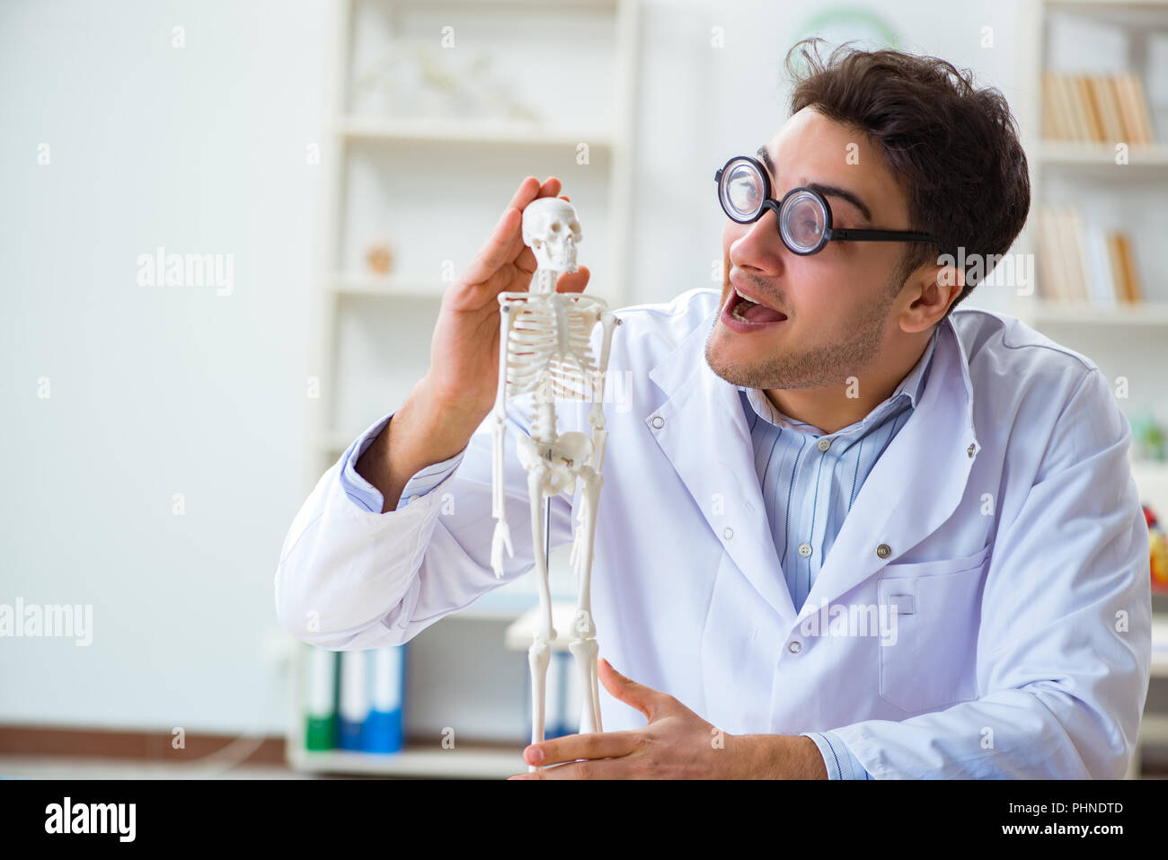 Crazy doctor studying human skeleton Stock Photo - Alamy
