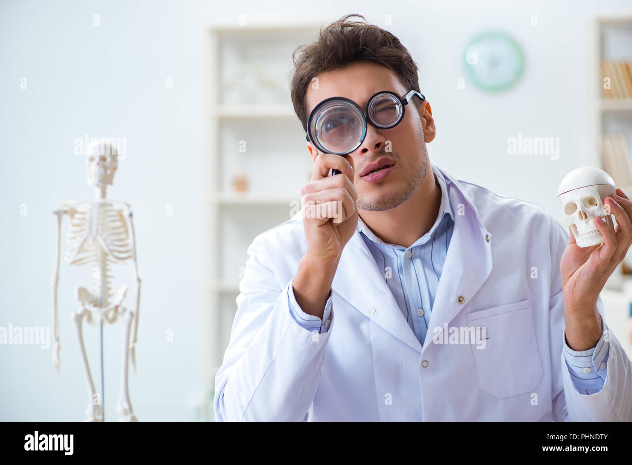 Crazy doctor studying human skeleton Stock Photo - Alamy