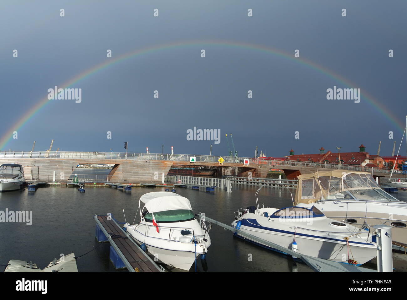 Boats under the rainbow Stock Photo - Alamy