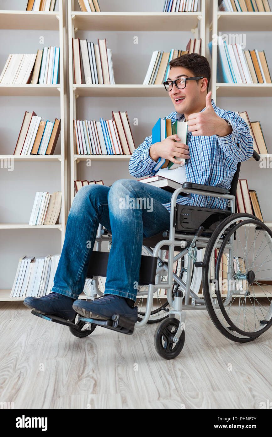 Disabled student studying in the library Stock Photo - Alamy