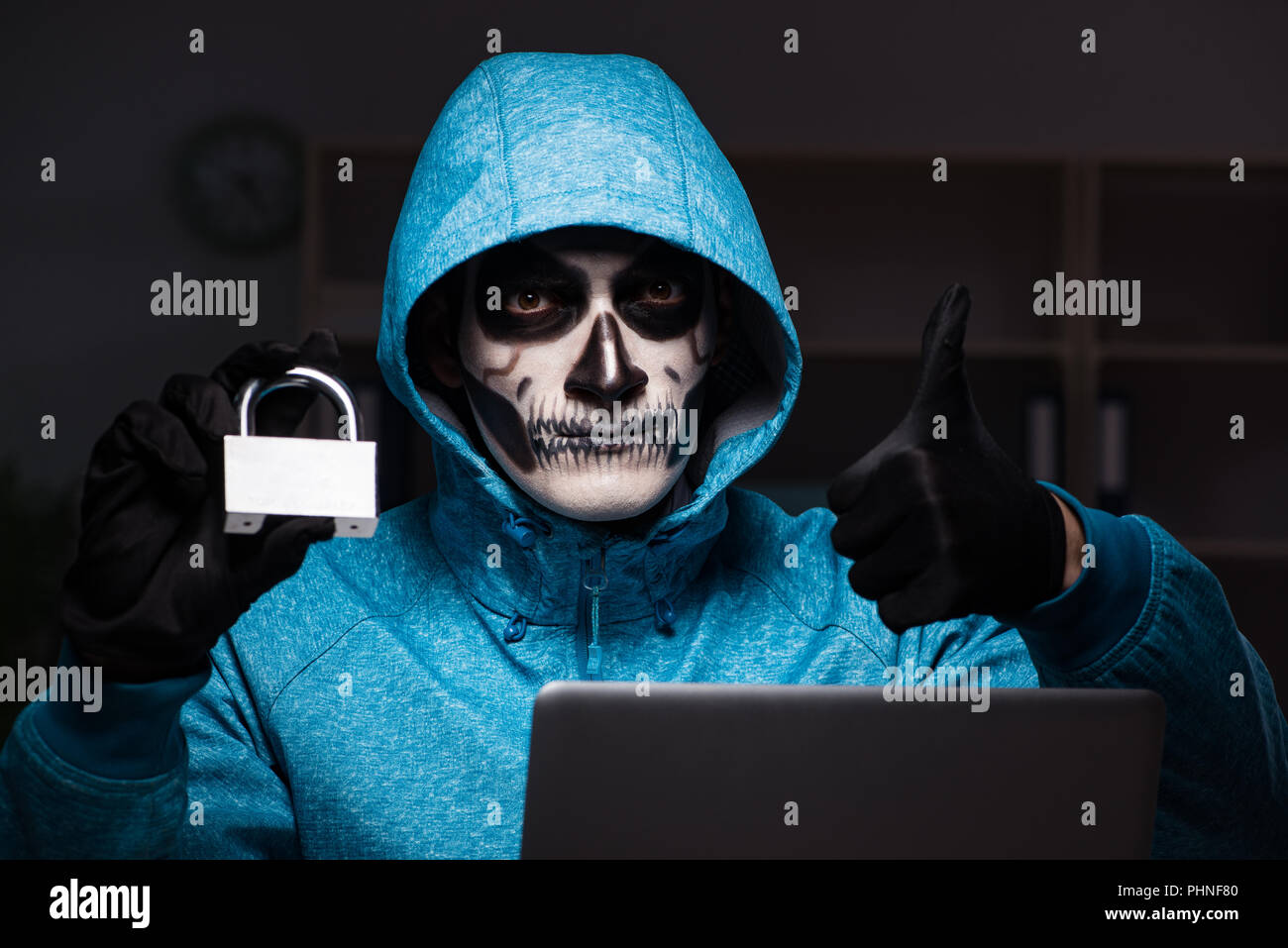 Scary hacker hacking security firewall late in office Stock Photo - Alamy