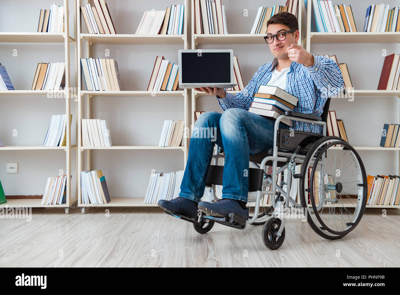 Disabled student studying in the library Stock Photo - Alamy