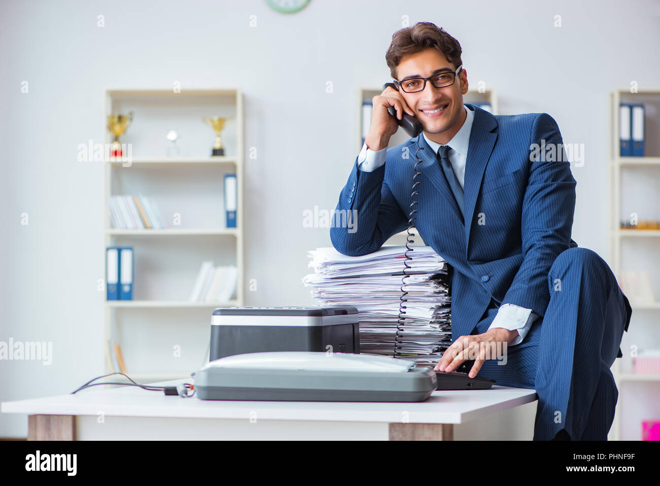 Businessman making copies in copying machine Stock Photo - Alamy