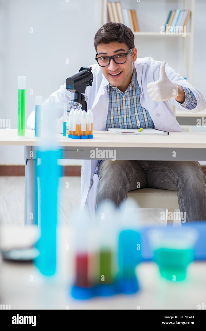 Young chemist student working in lab on chemicals Stock Photo - Alamy