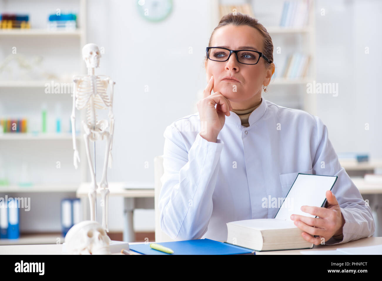 Woman doctor studying human skeleton Stock Photo - Alamy