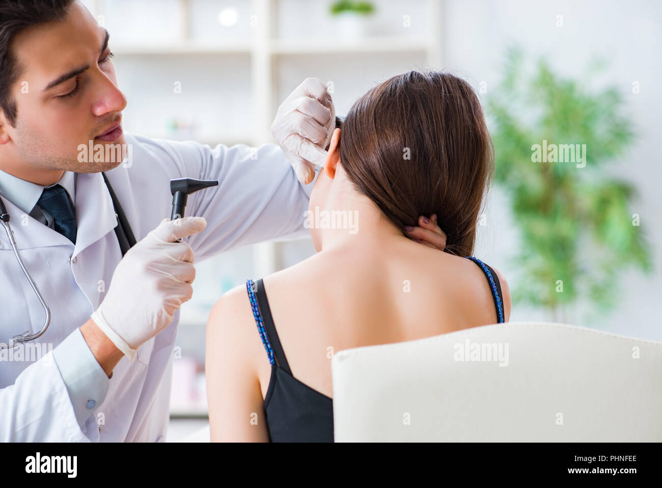 Doctor checking patients ear during medical examination Stock Photo - Alamy