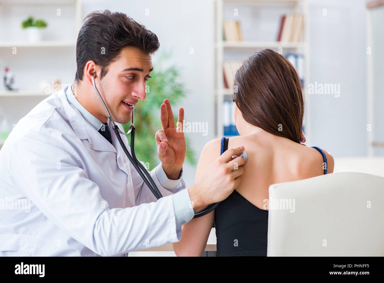 Doctor checking patient with stethoscope Stock Photo - Alamy