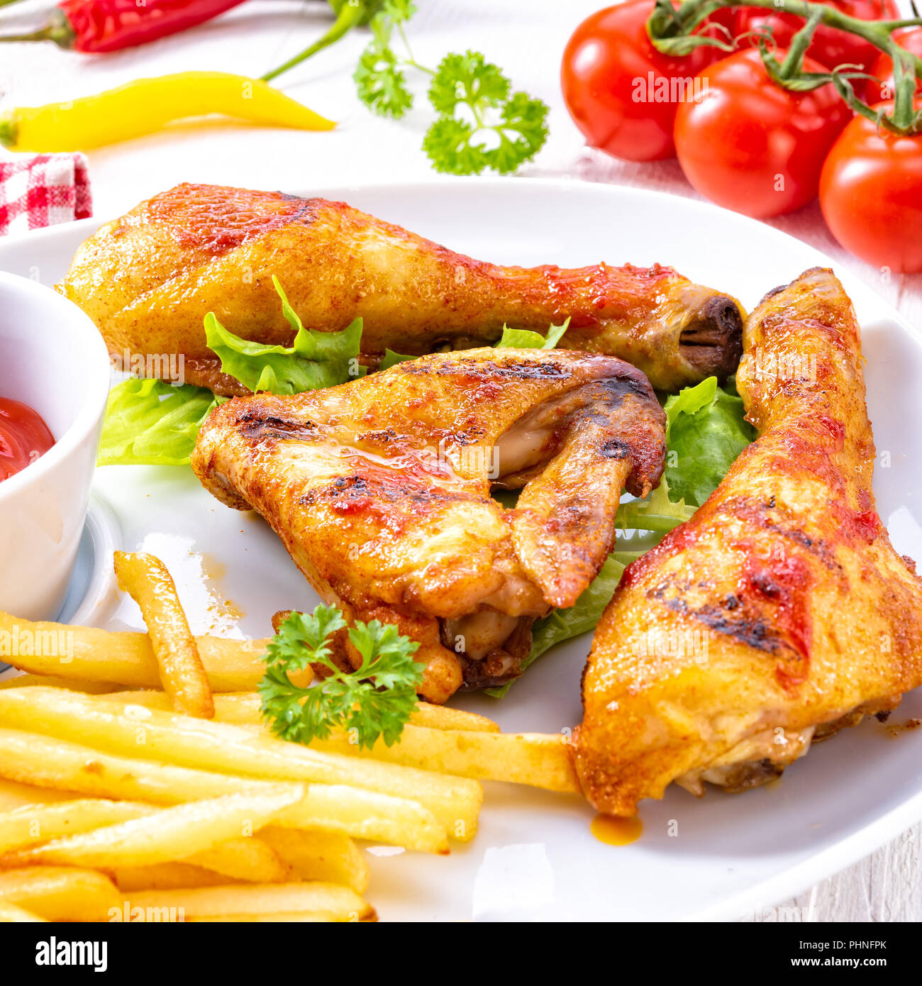 Grilled chicken wings,legs,chips and vegetables Stock Photo - Alamy