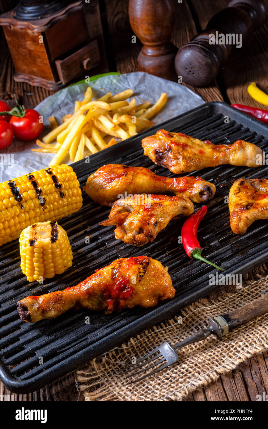 Rustic Grilled chicken wings,legs,and spicy corn Stock Photo - Alamy