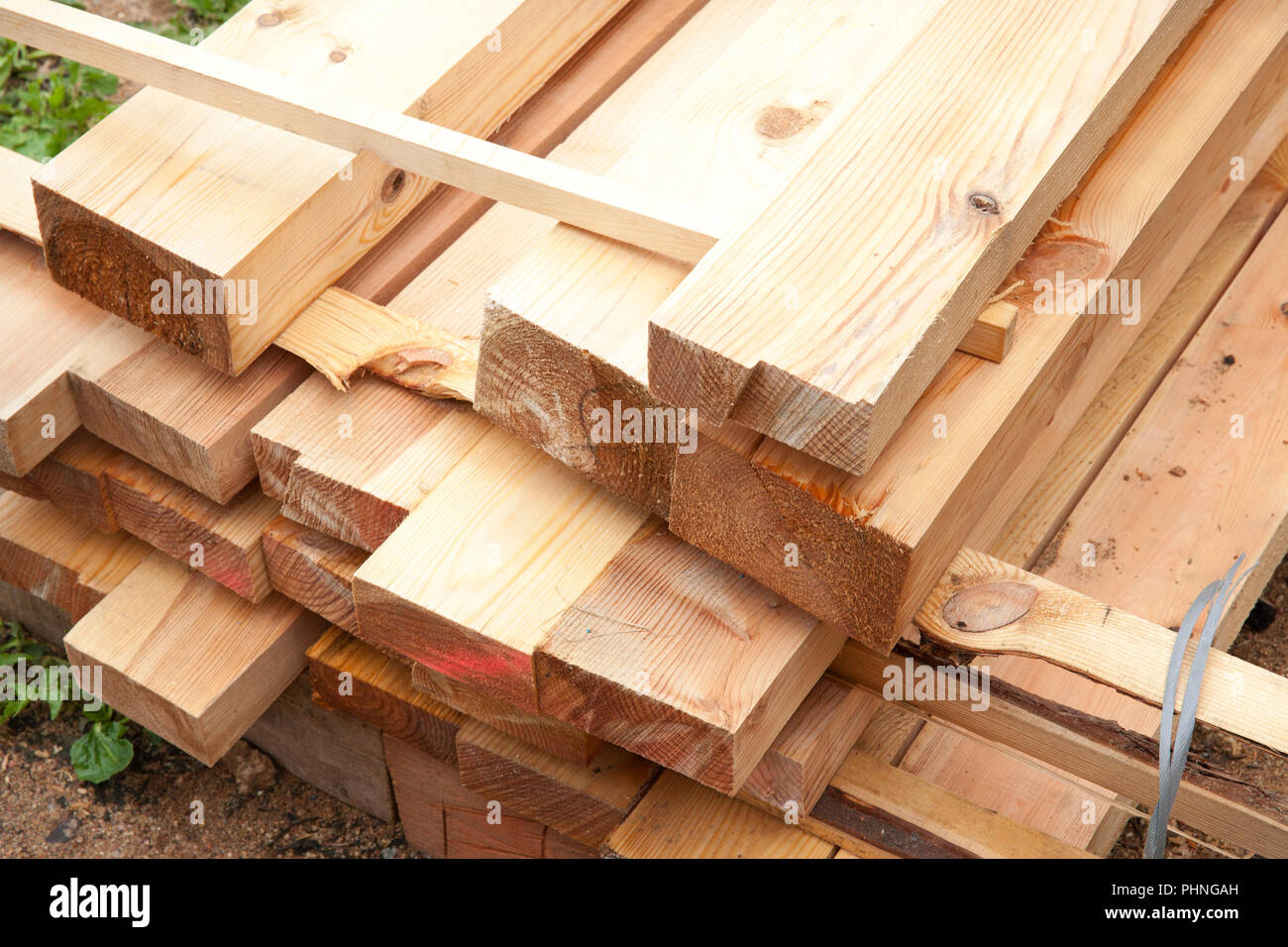 folded pine boards and beams for use in construction, closeup on the ...