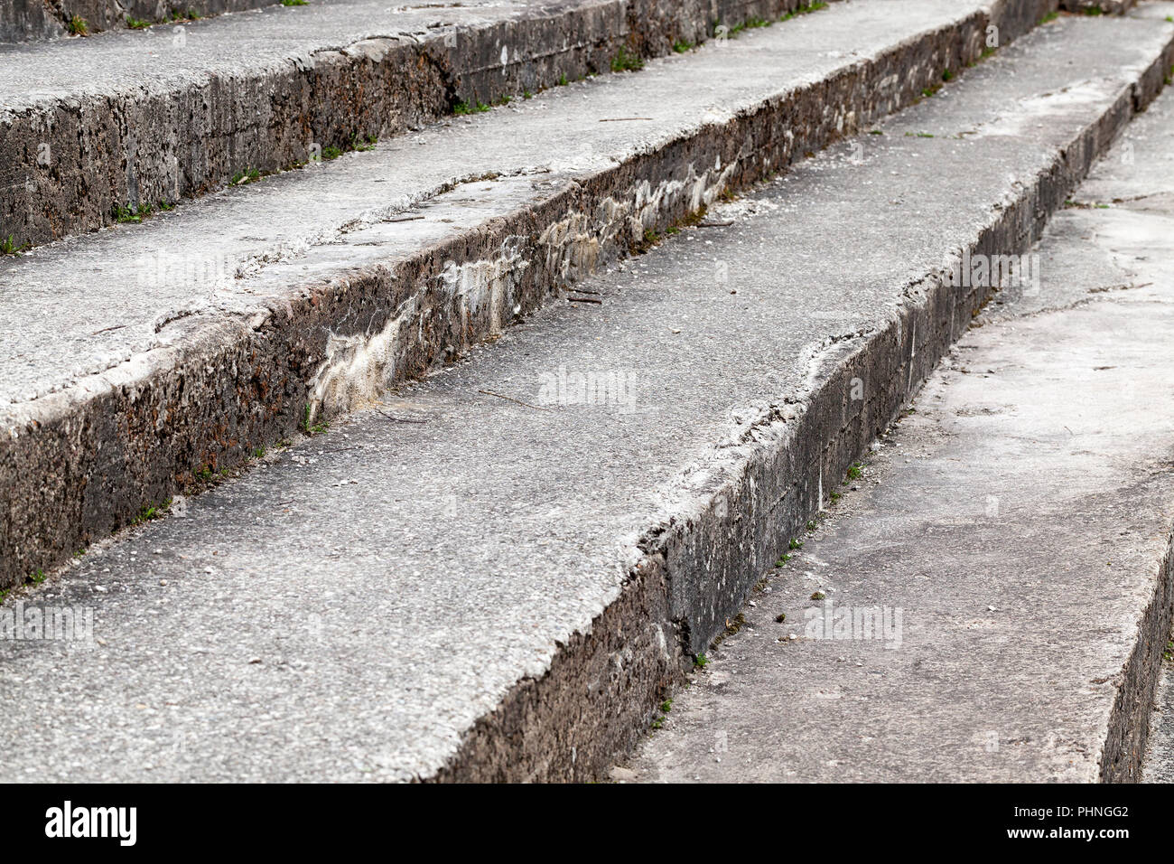 crumbling old concrete staircase made of cement, closeup in an old park ...