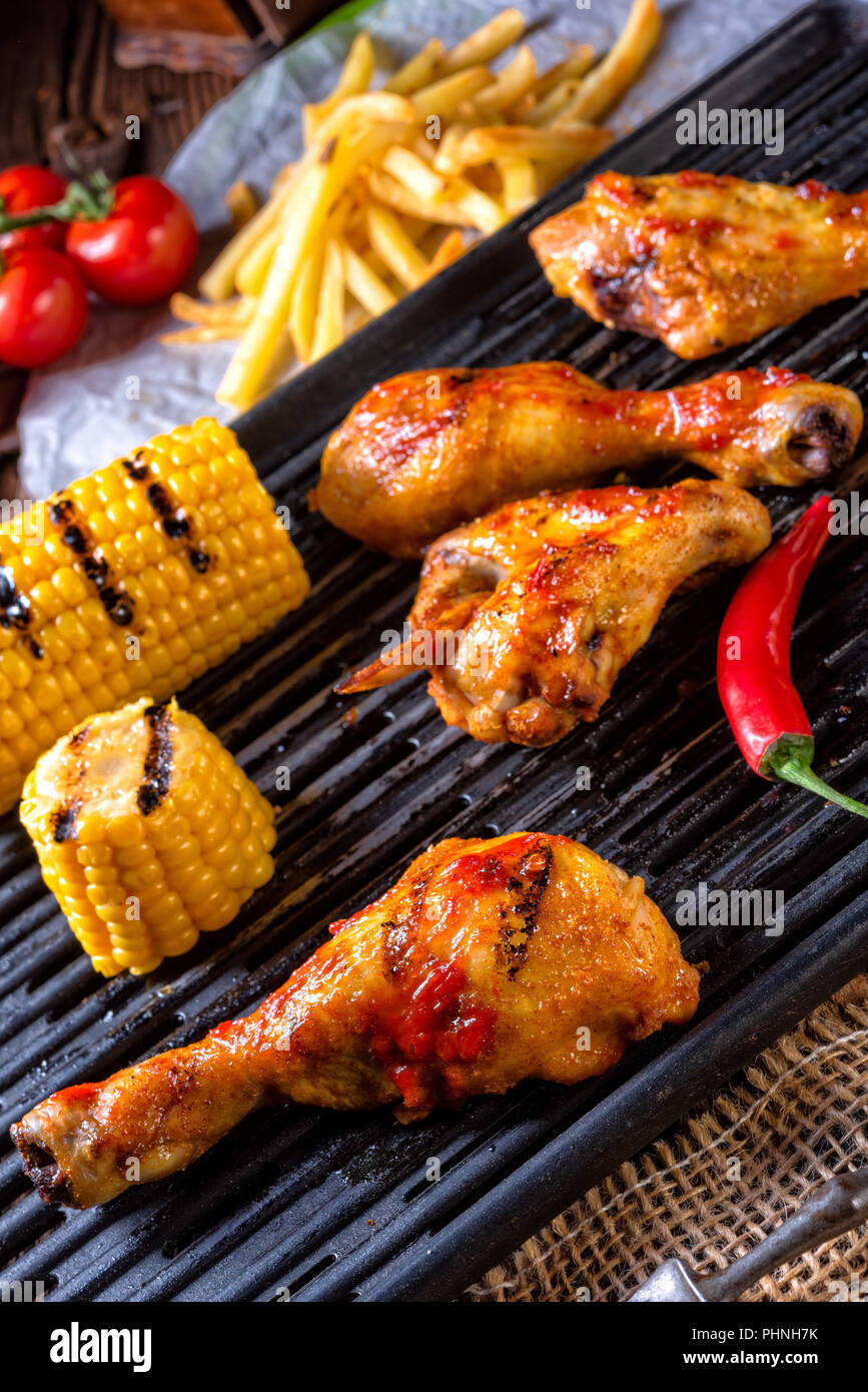 Rustic Grilled chicken wings,legs,and spicy corn Stock Photo - Alamy