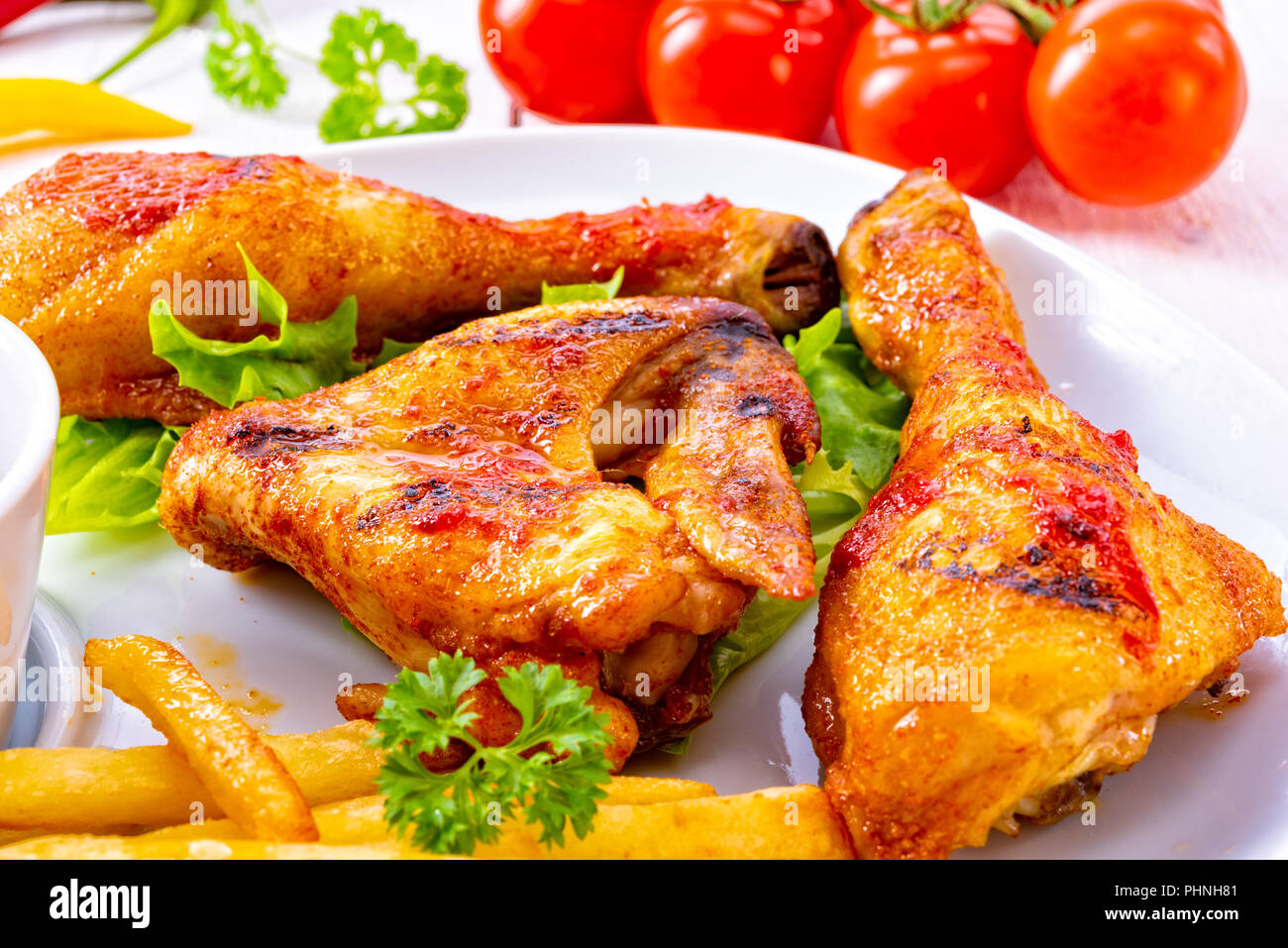 Grilled chicken wings,legs,chips and vegetables Stock Photo - Alamy