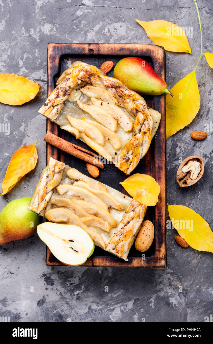 Rustic pie with pears and fallen autumn foliage. Autumn kitchen Stock ...