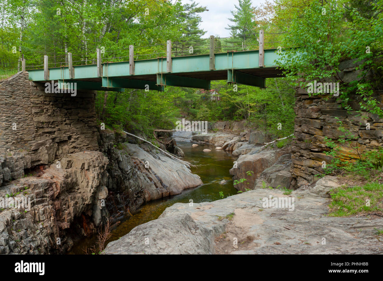 A beam bridge spans over the canyon carved out by Swift River. Coos ...