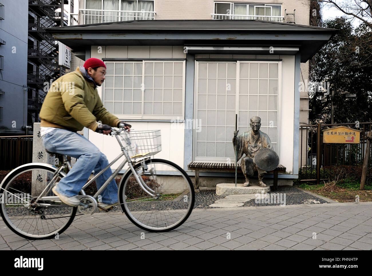 A man cycles past a bronze memorial statue of renowned 17th-century ...
