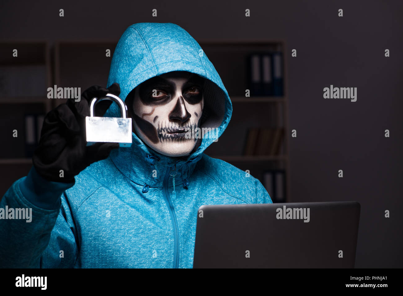 Scary hacker hacking security firewall late in office Stock Photo - Alamy