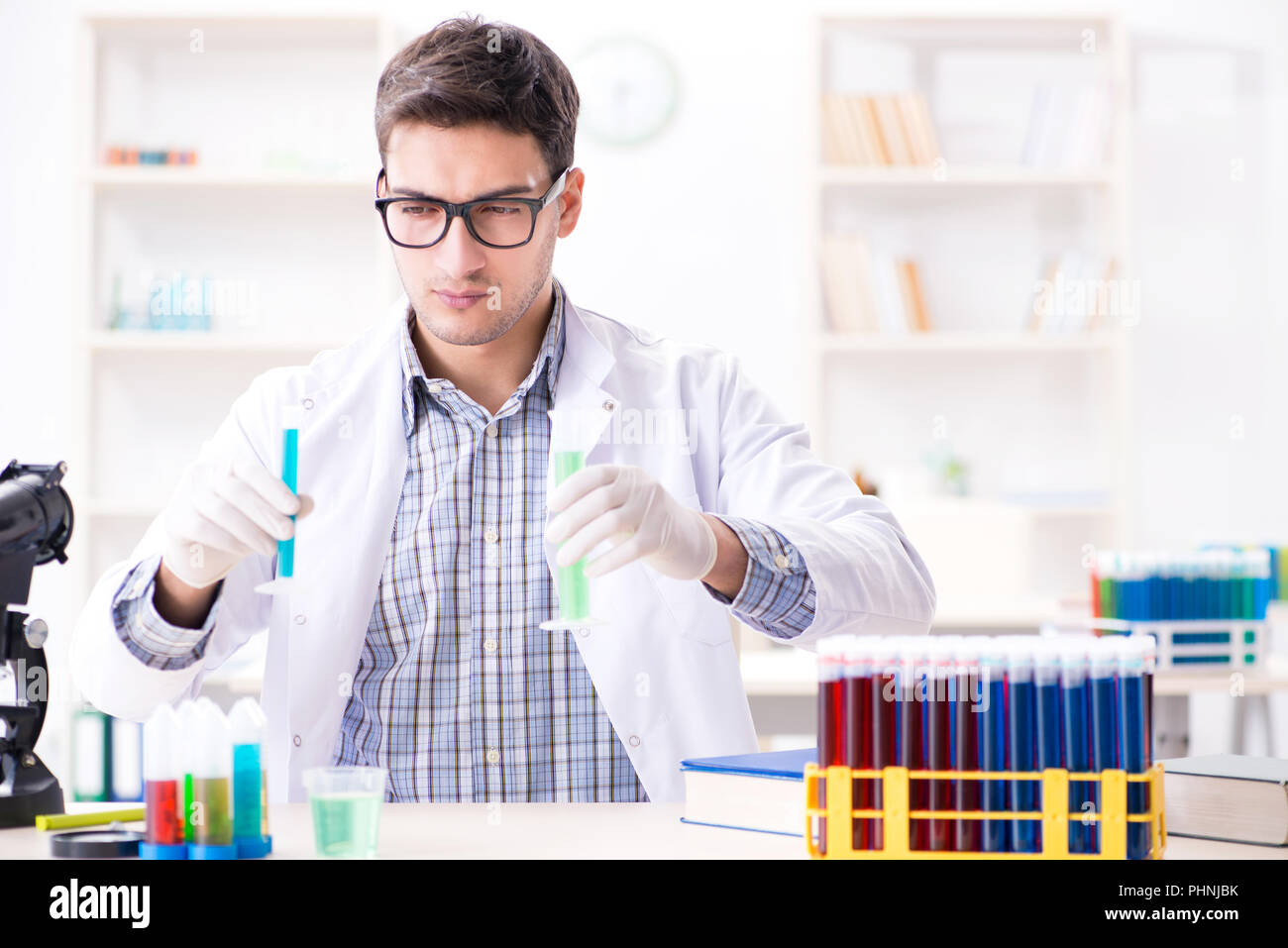 Chemistry student doing chemical experiments at classroom activi Stock ...