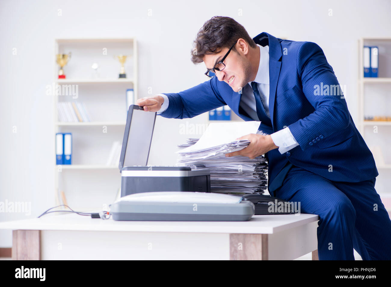 Businessman making copies in copying machine Stock Photo - Alamy