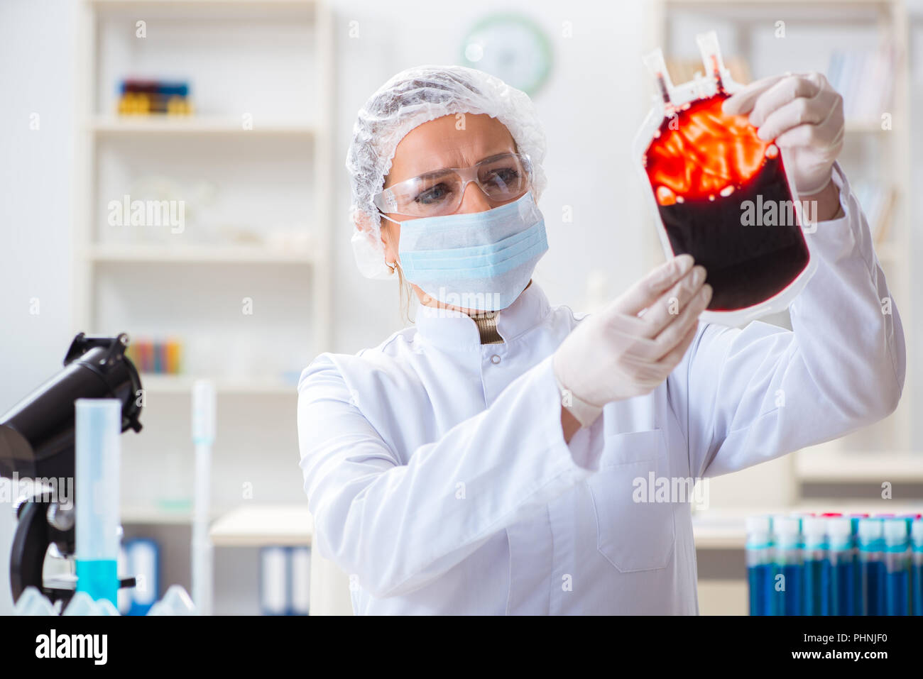 Woman doctor checking blood samples in lab Stock Photo - Alamy
