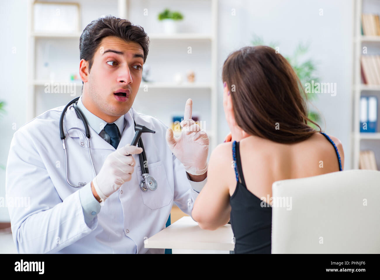 Doctor checking patients ear during medical examination Stock Photo - Alamy