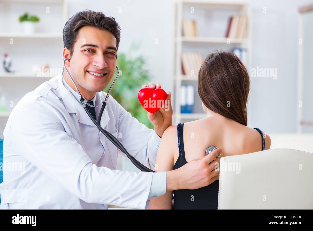 Doctor checking patient with stethoscope Stock Photo - Alamy