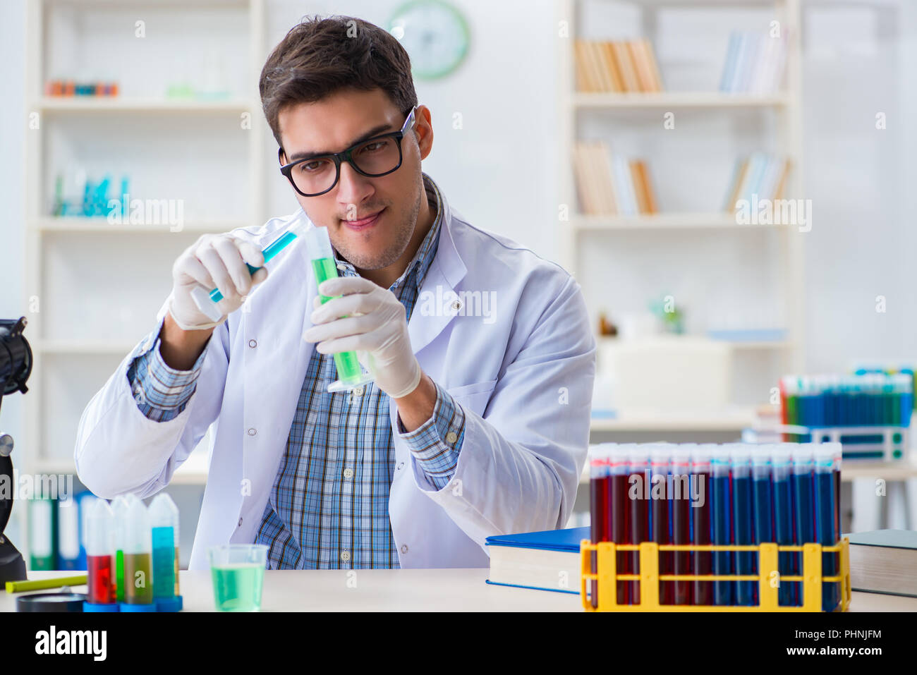 Young chemist student working in lab on chemicals Stock Photo - Alamy
