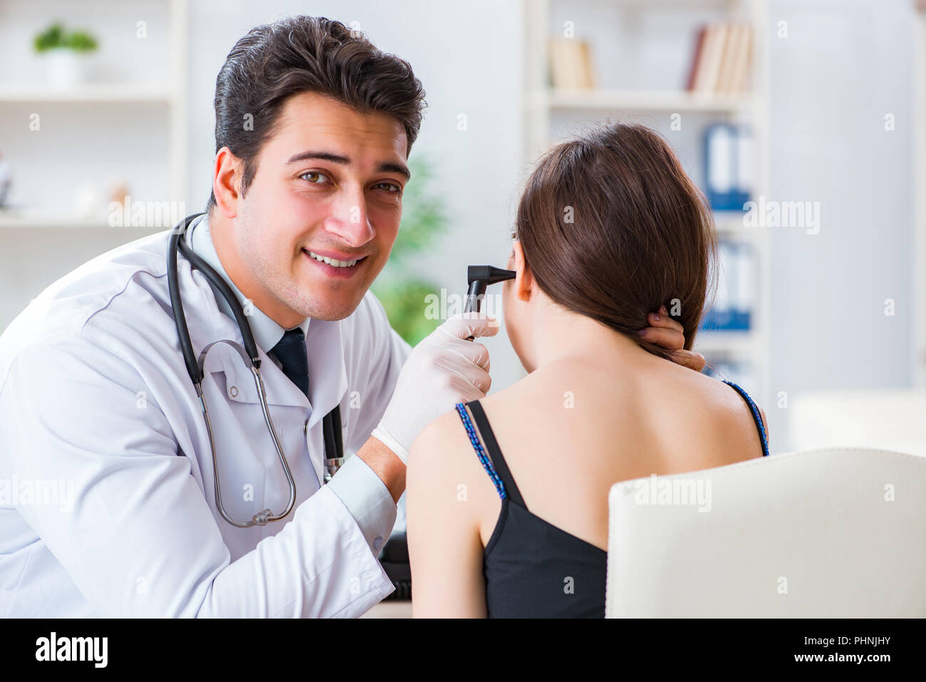 Doctor checking patients ear during medical examination Stock Photo - Alamy