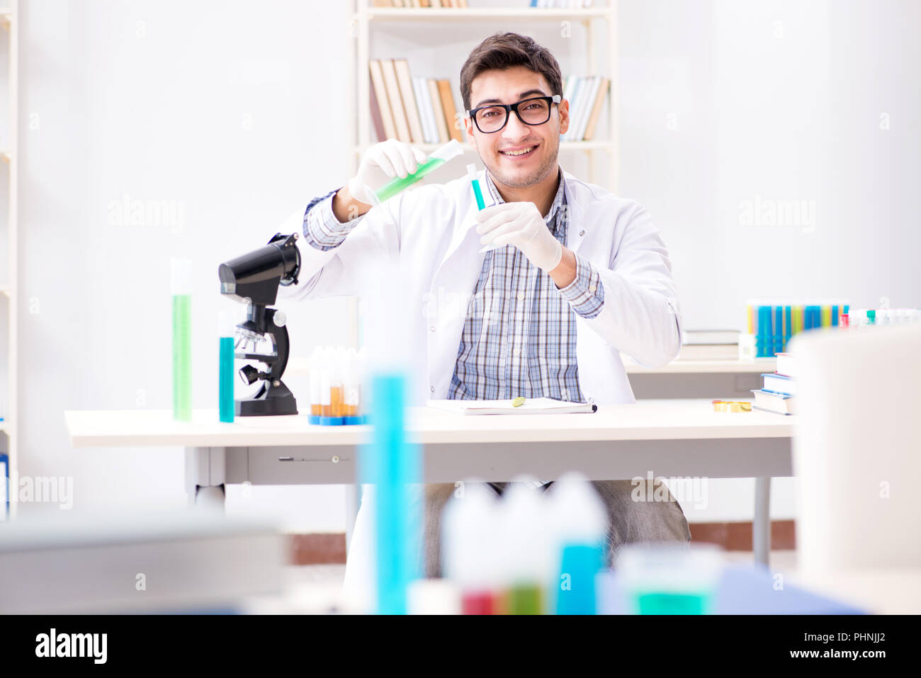 Chemistry student doing chemical experiments at classroom activi Stock ...
