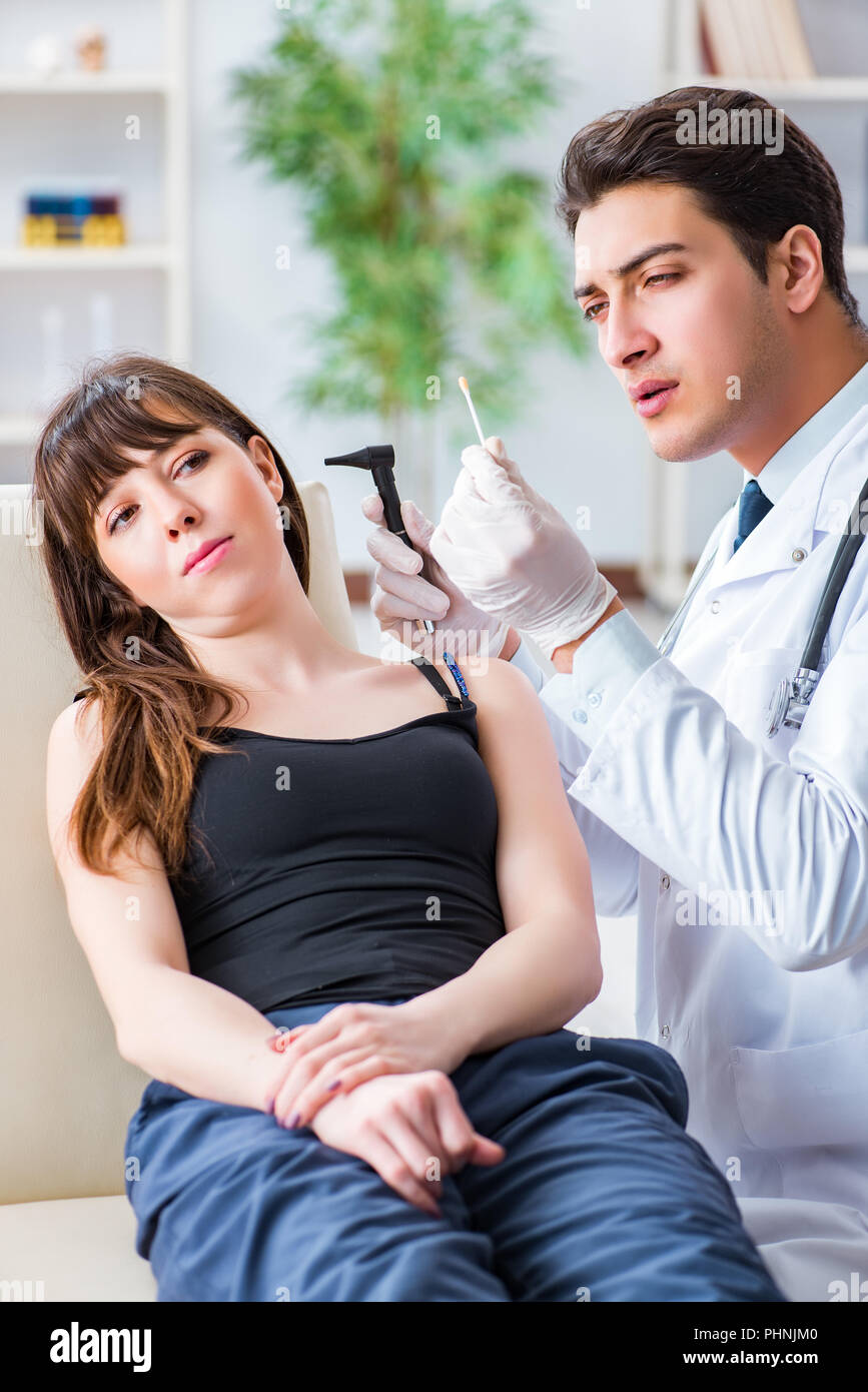 Doctor checking patient's ear hi-res stock photography and images - Alamy