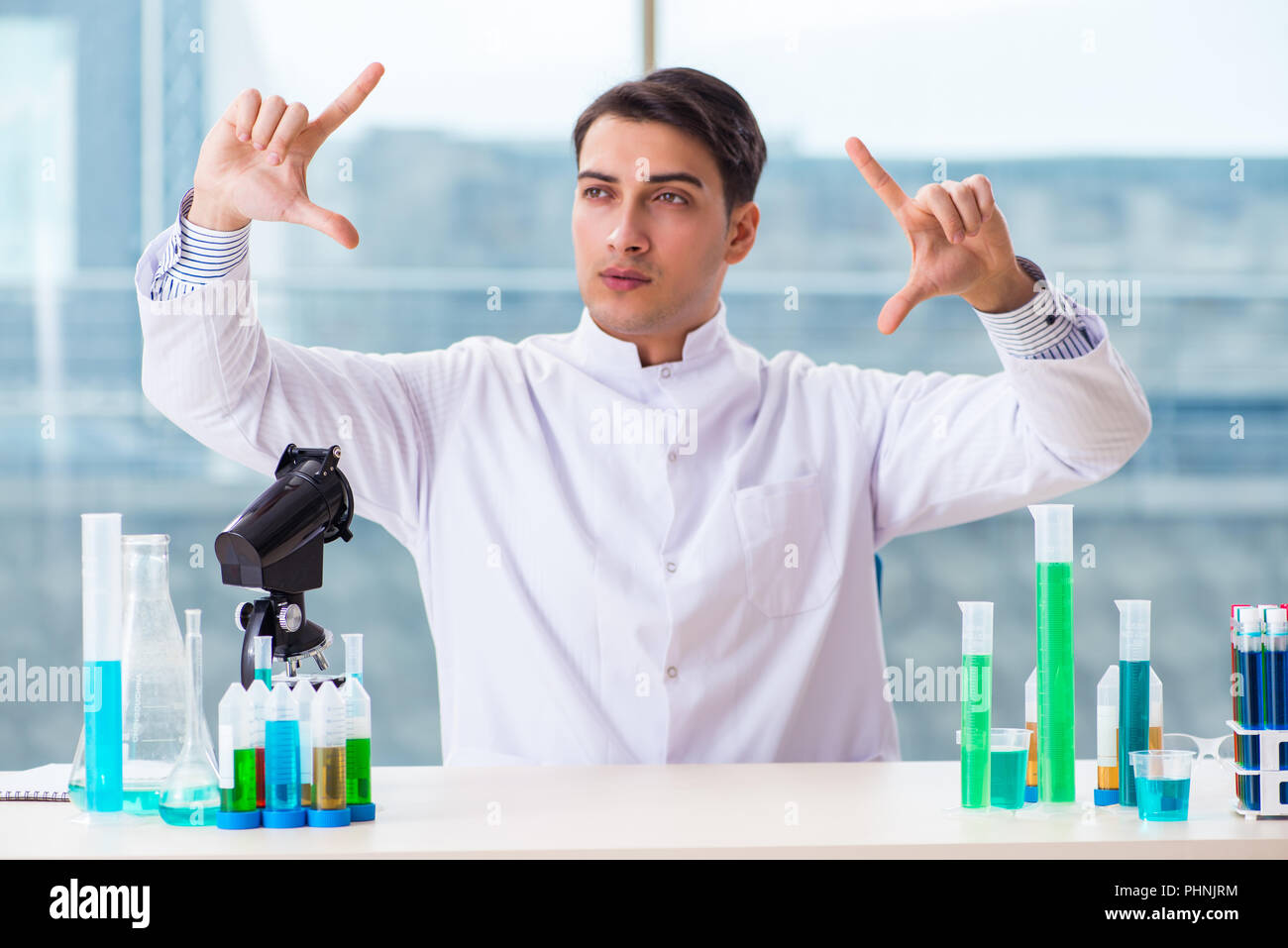 Young chemist pressing virtual buttons in lab Stock Photo - Alamy