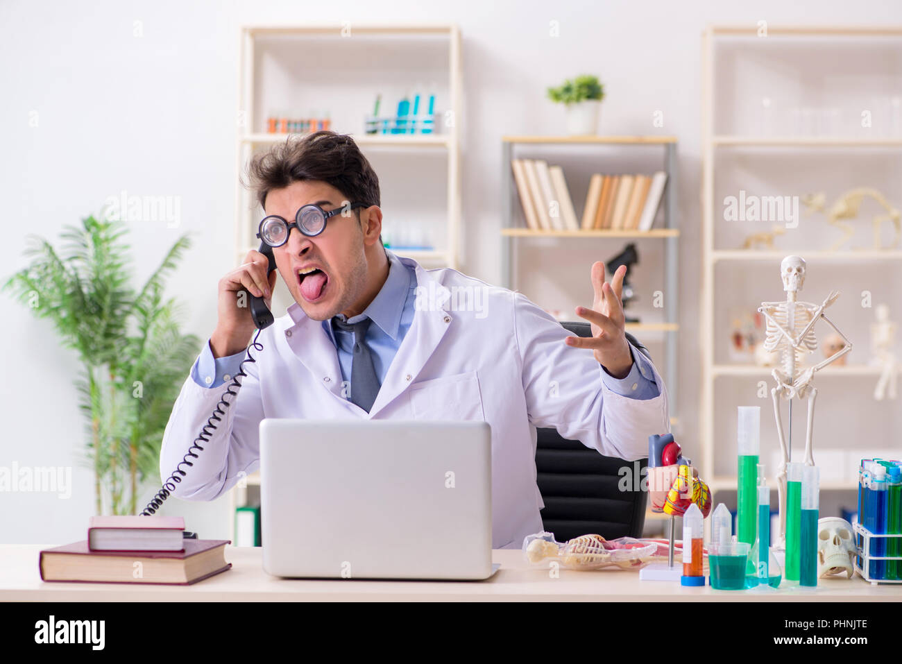 Funny doctor having fun in hospital lab Stock Photo - Alamy