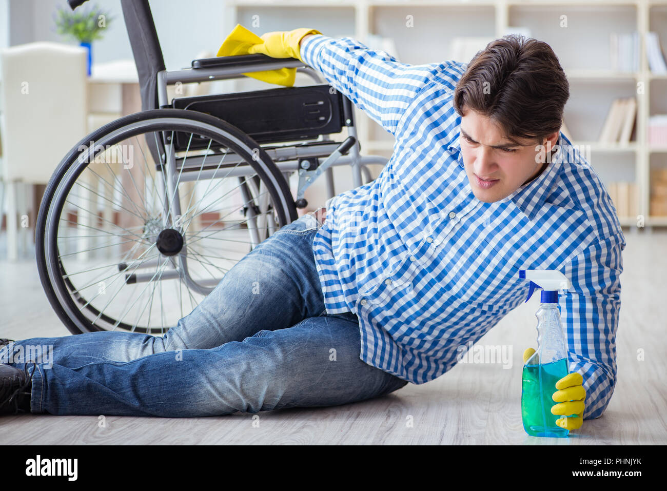 Disabled man on wheelchair cleaning home Stock Photo - Alamy
