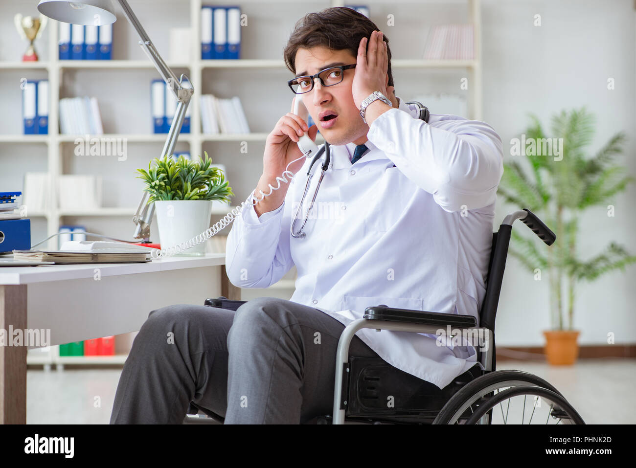 Disabled doctor on wheelchair working in hospital Stock Photo - Alamy