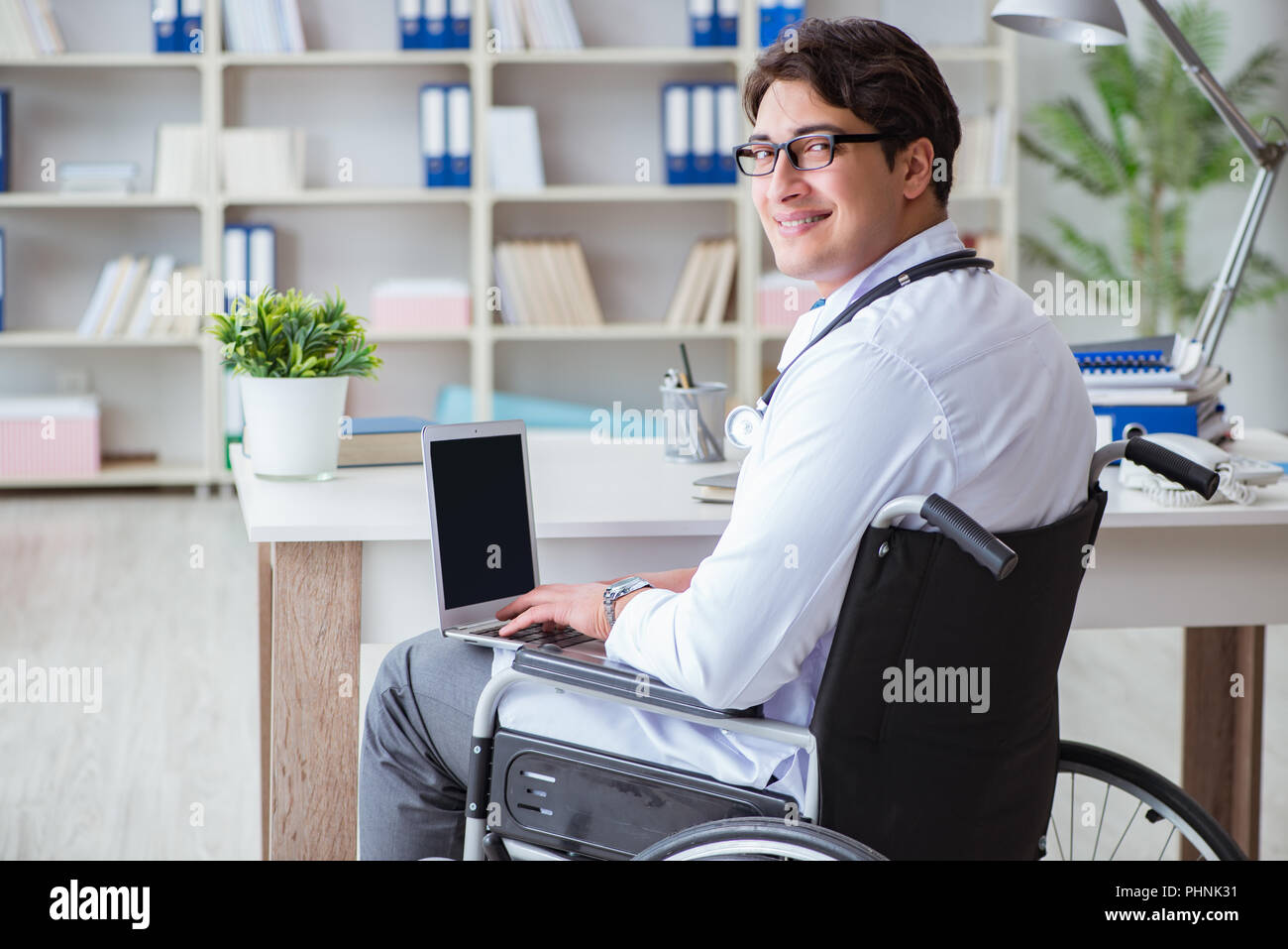 Disabled doctor on wheelchair working in hospital Stock Photo - Alamy
