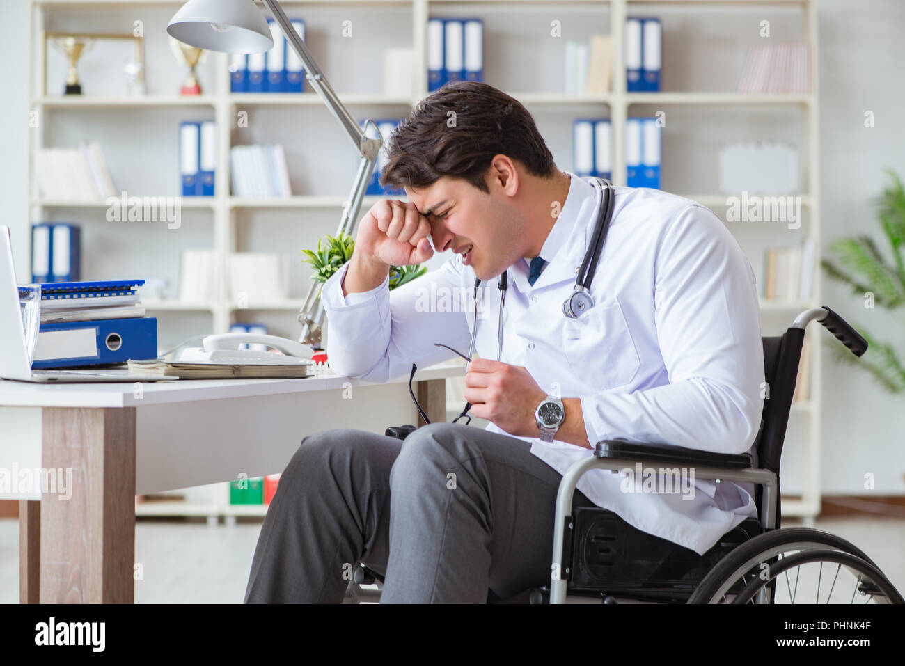 Disabled doctor on wheelchair working in hospital Stock Photo - Alamy