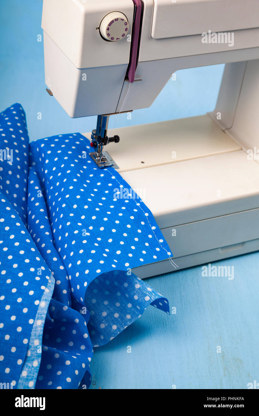 Sewing machine and blue fabric close-up Stock Photo - Alamy