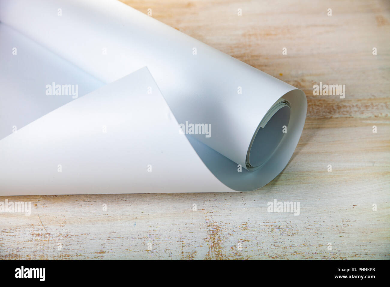 Roll of white paper on a wooden background Stock Photo - Alamy