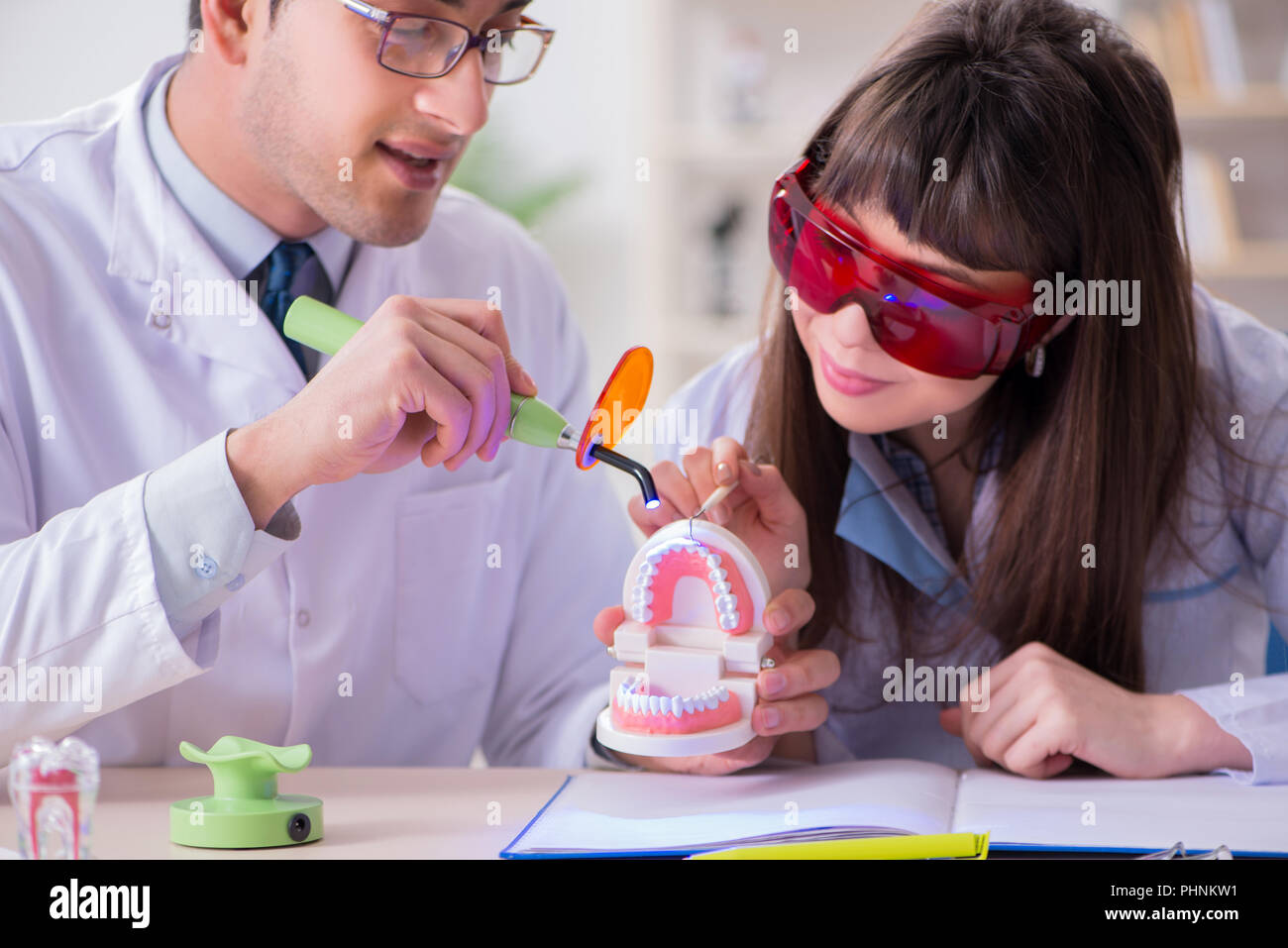 Doctor explaining to assistant how to use ultraviolet gun Stock Photo ...