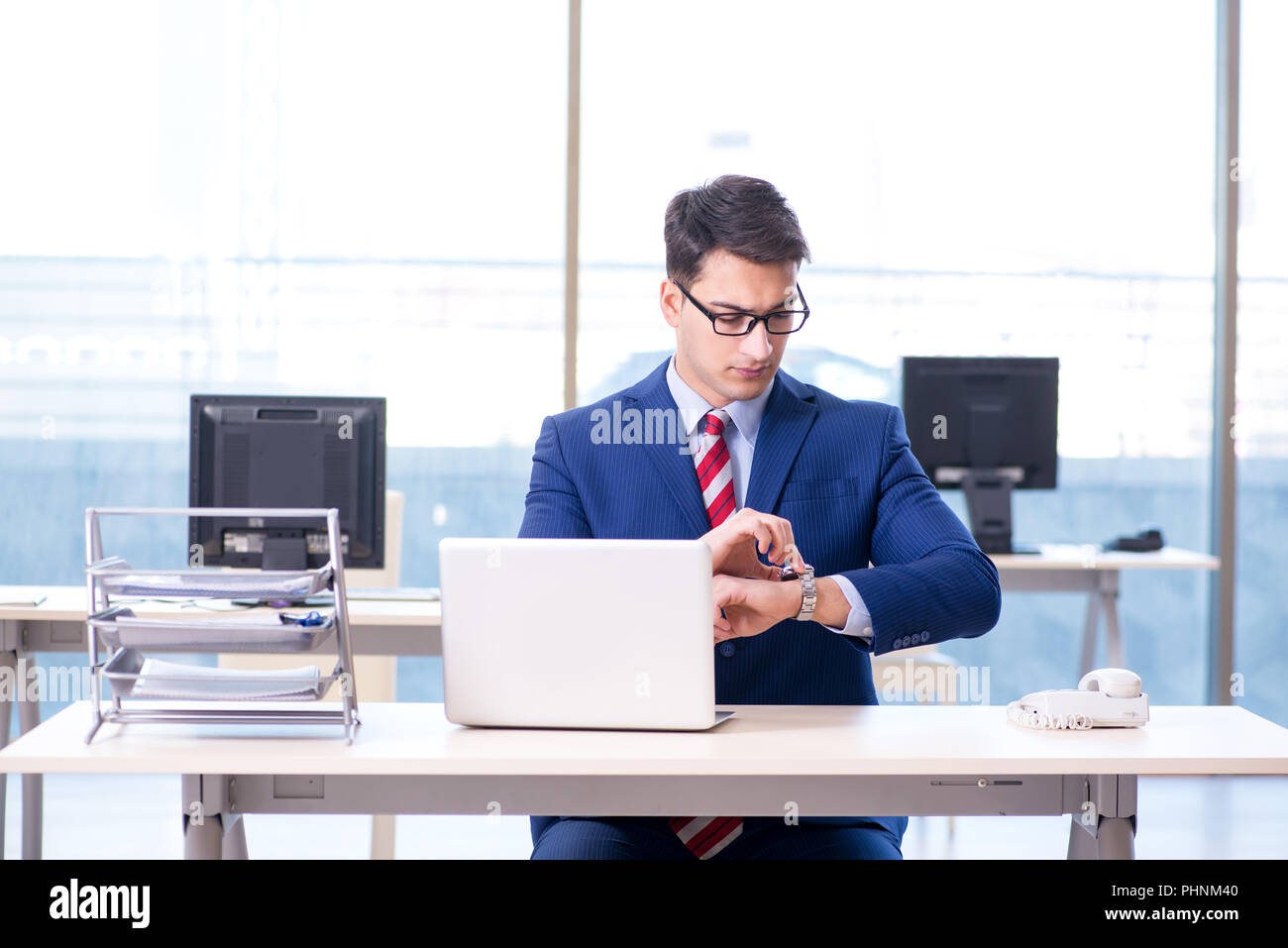 Young handsome businessman employee working in office at desk Stock ...