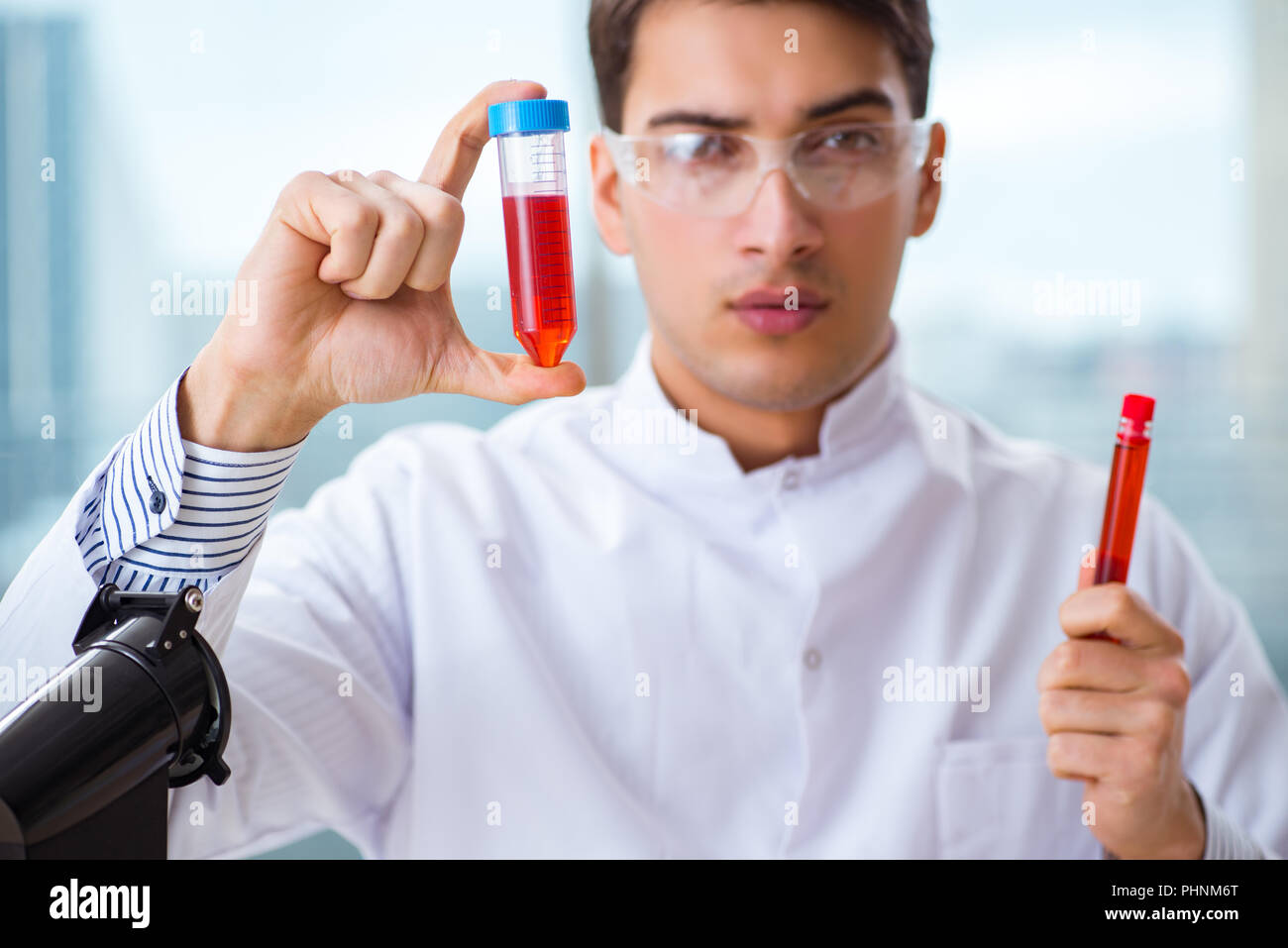 Man doctor checking blood samples in lab Stock Photo - Alamy