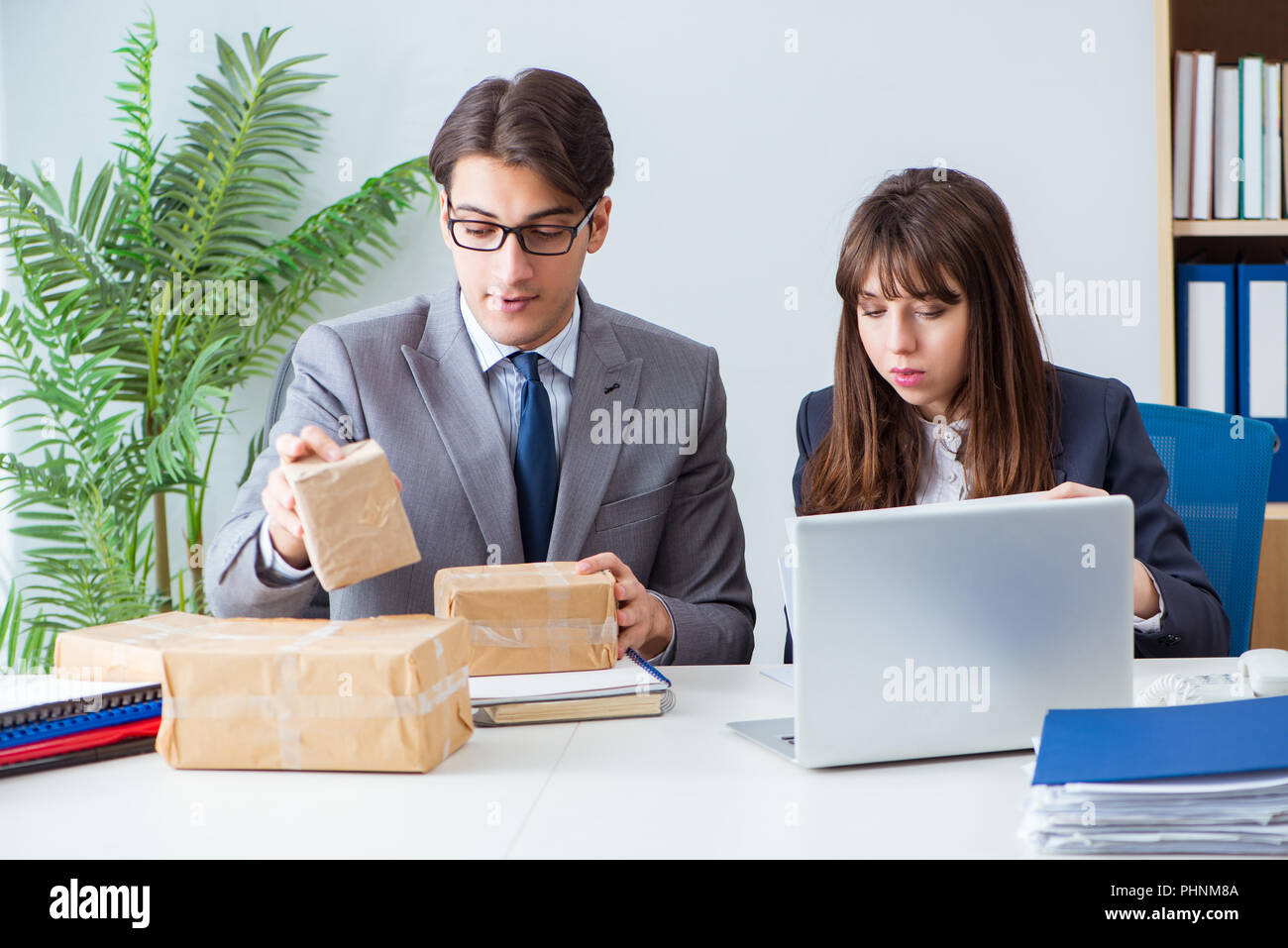 Business people receiving new mail and parcels Stock Photo - Alamy