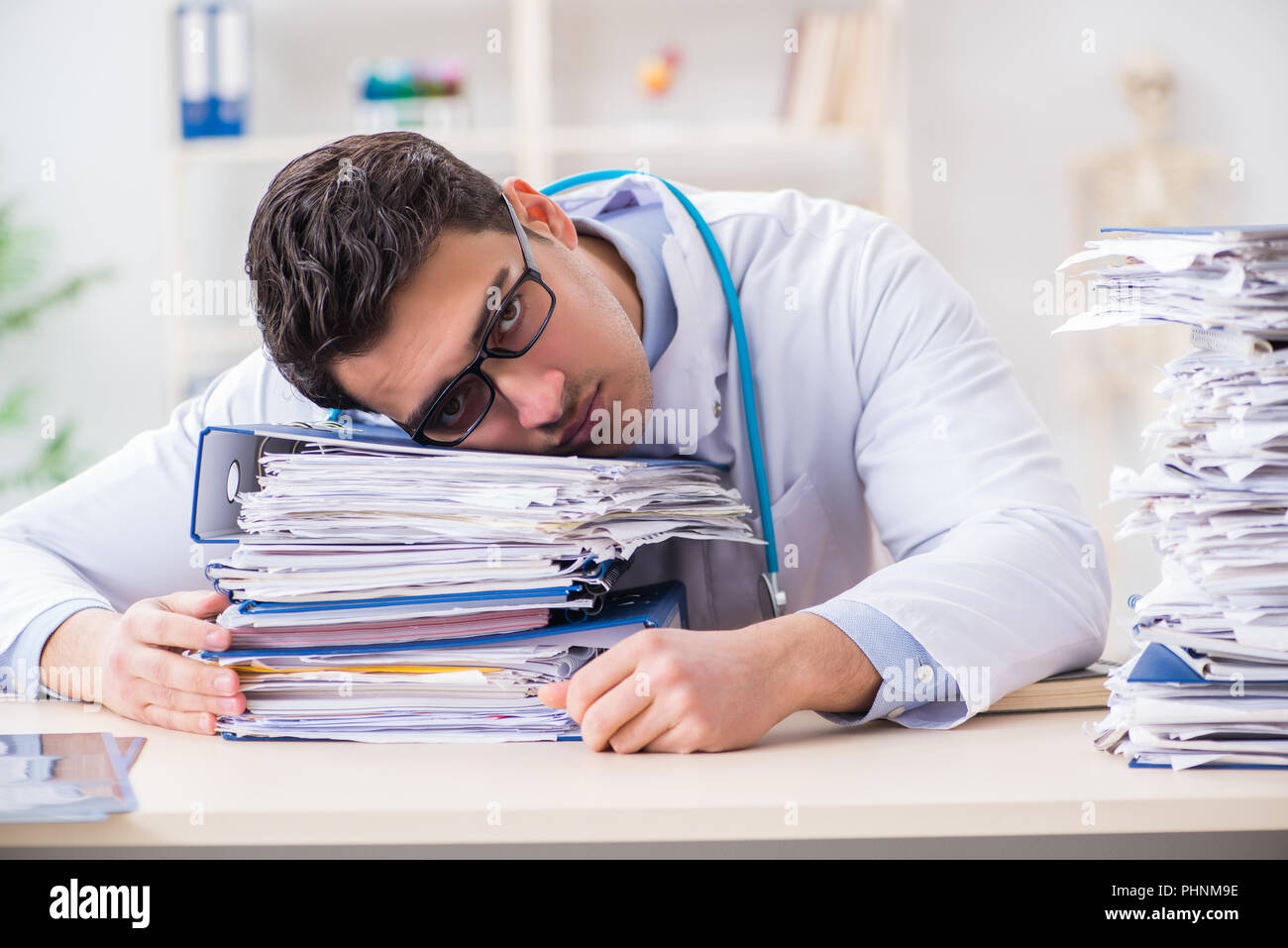 Busy doctor with too much work in hospital Stock Photo - Alamy