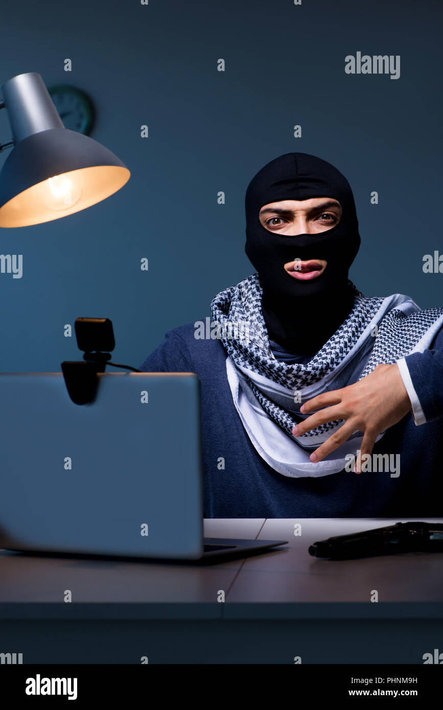 Hacker wearing balaclava mask hacking computer Stock Photo - Alamy