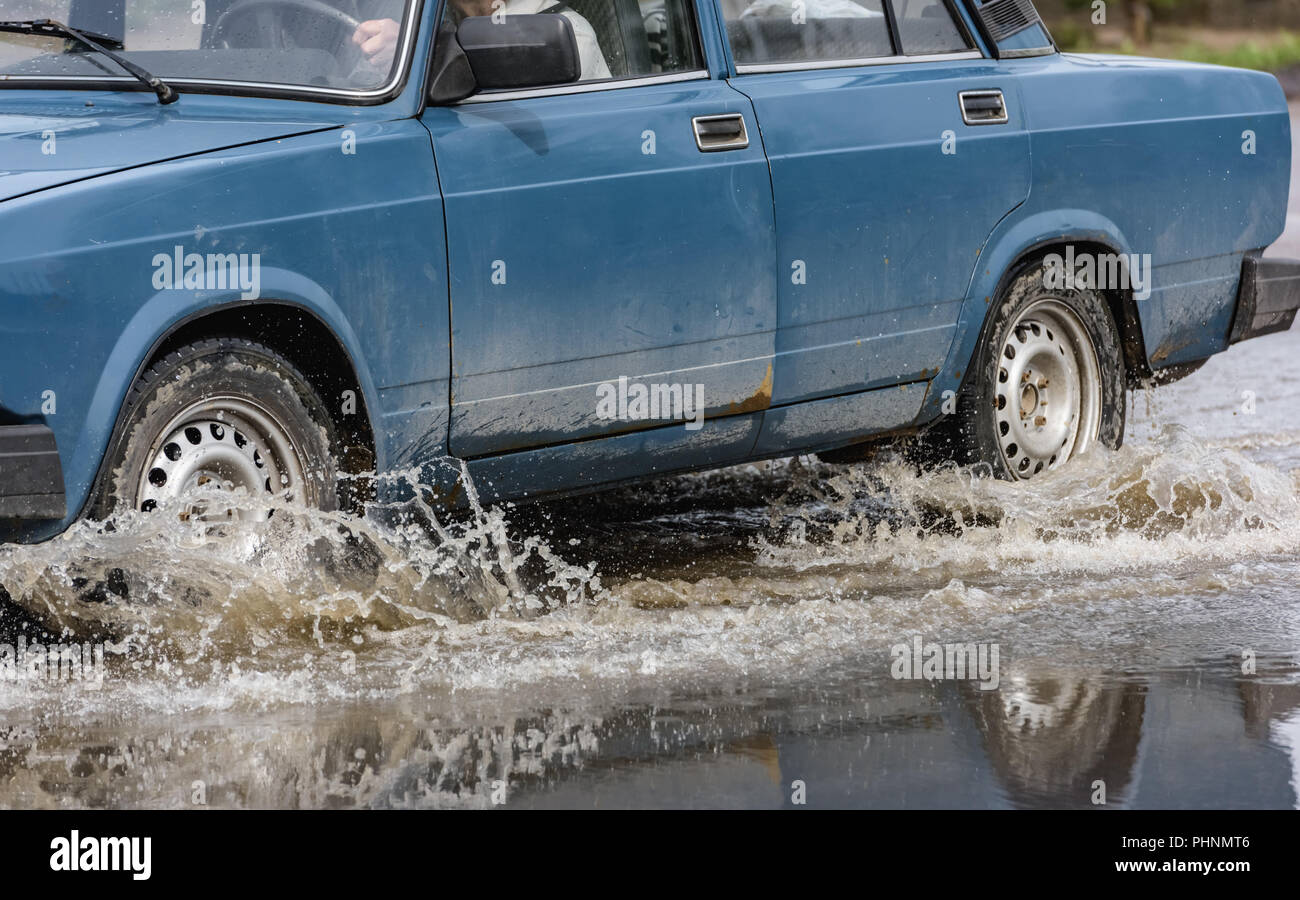 car rain puddle splashing water Stock Photo - Alamy