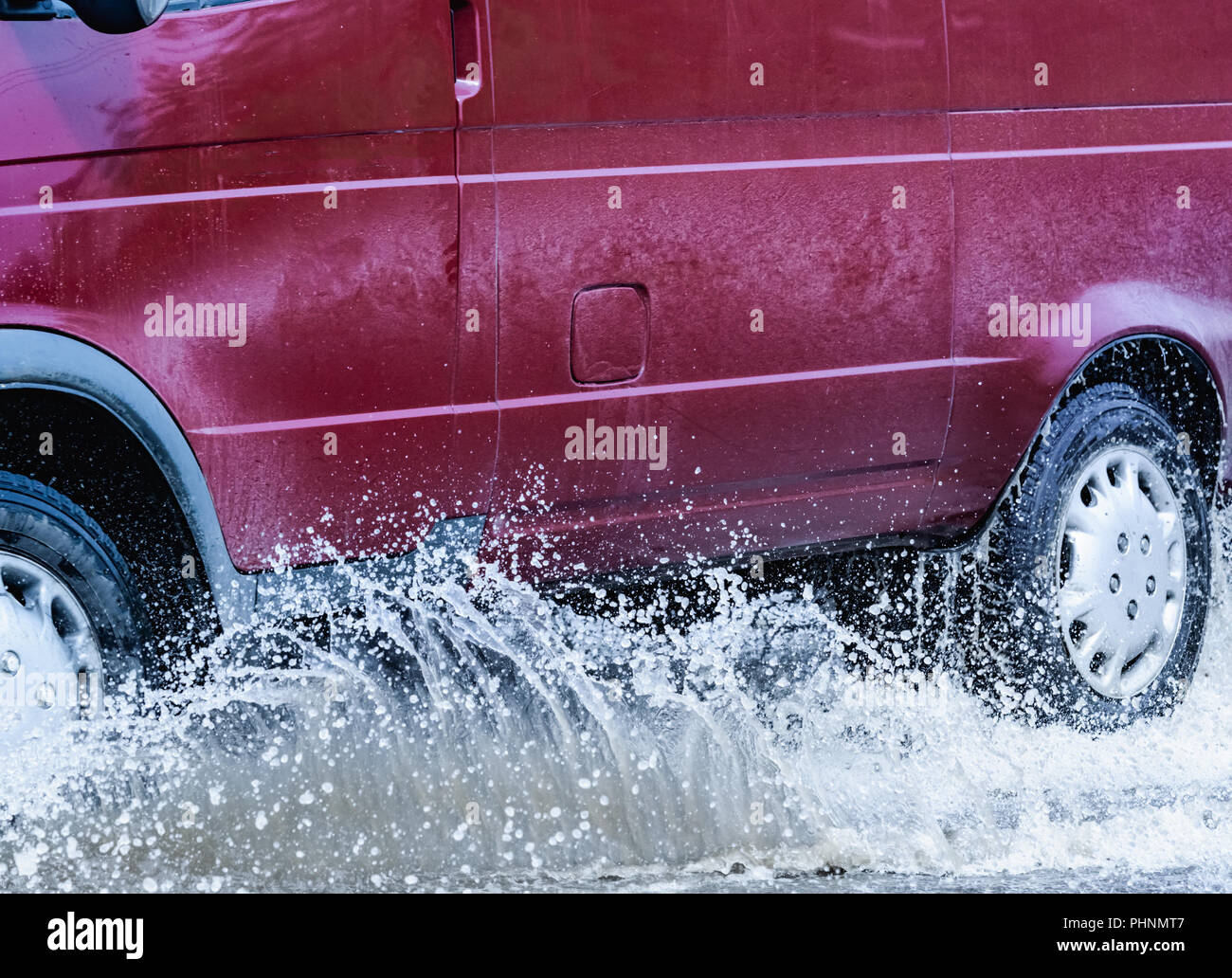 car rain puddle splashing water Stock Photo - Alamy