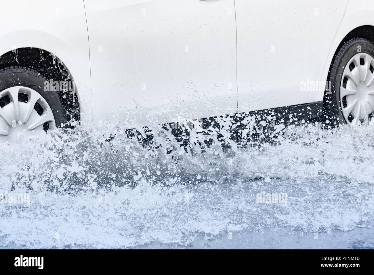 car rain puddle splashing water Stock Photo - Alamy